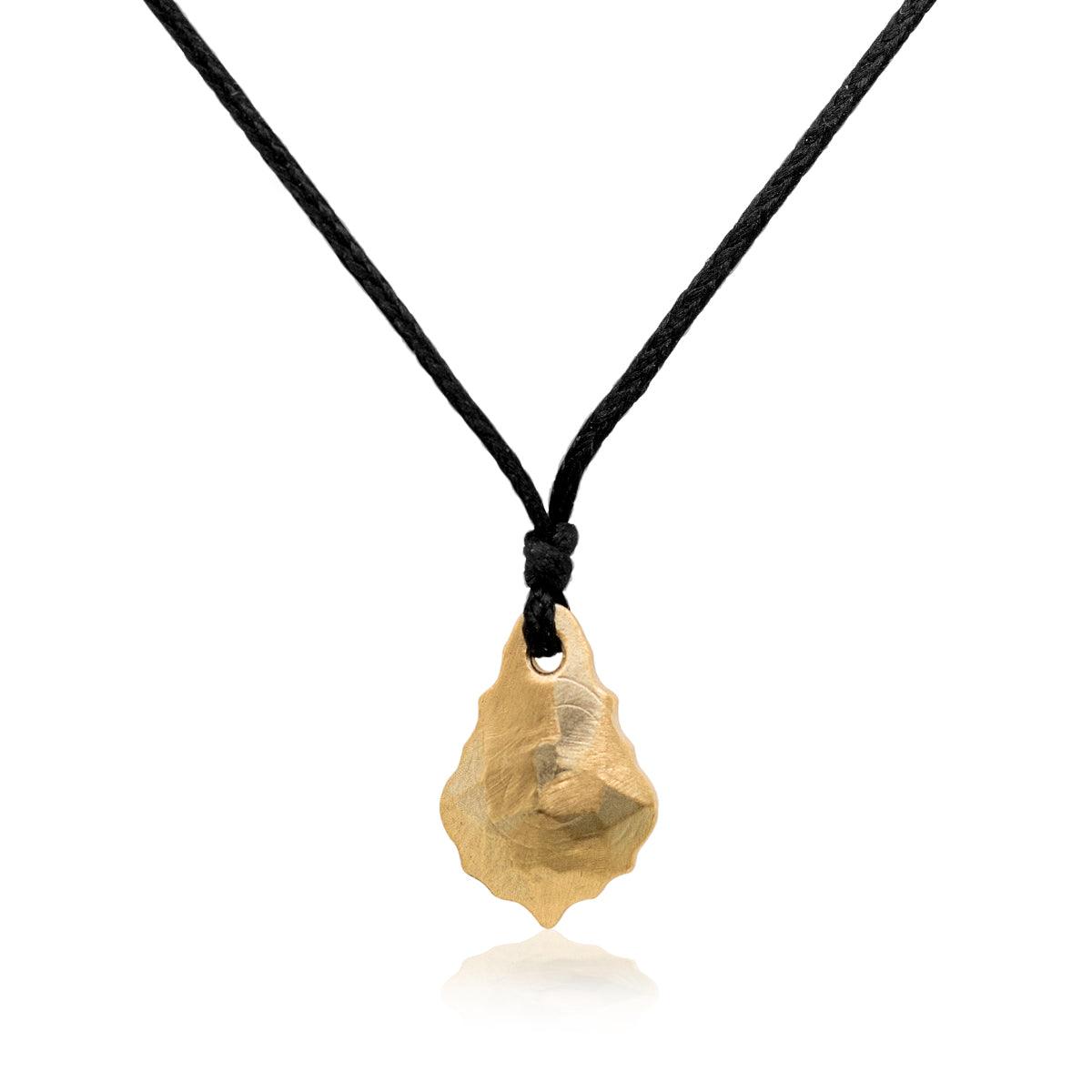 A black drawstring necklace with a gold clasp. The pendant is a drop of ...